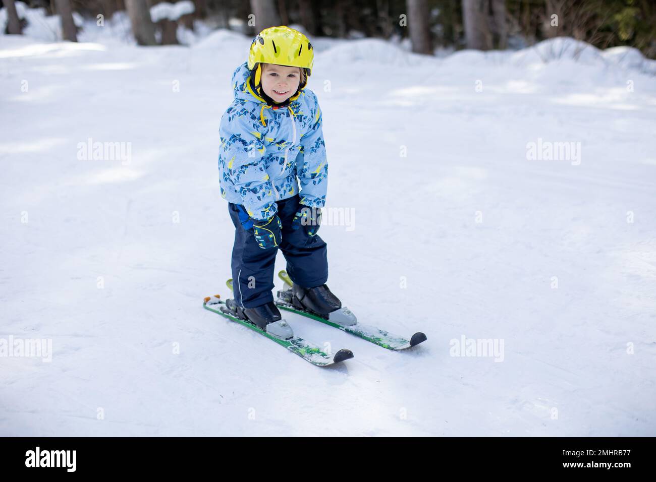 Little toddler boy, preschool child, skiing for the first time on small ...