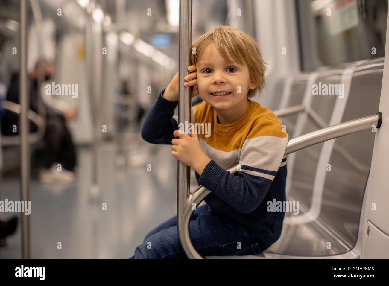 Children, traveling on the subway early in the morning, empty train ...