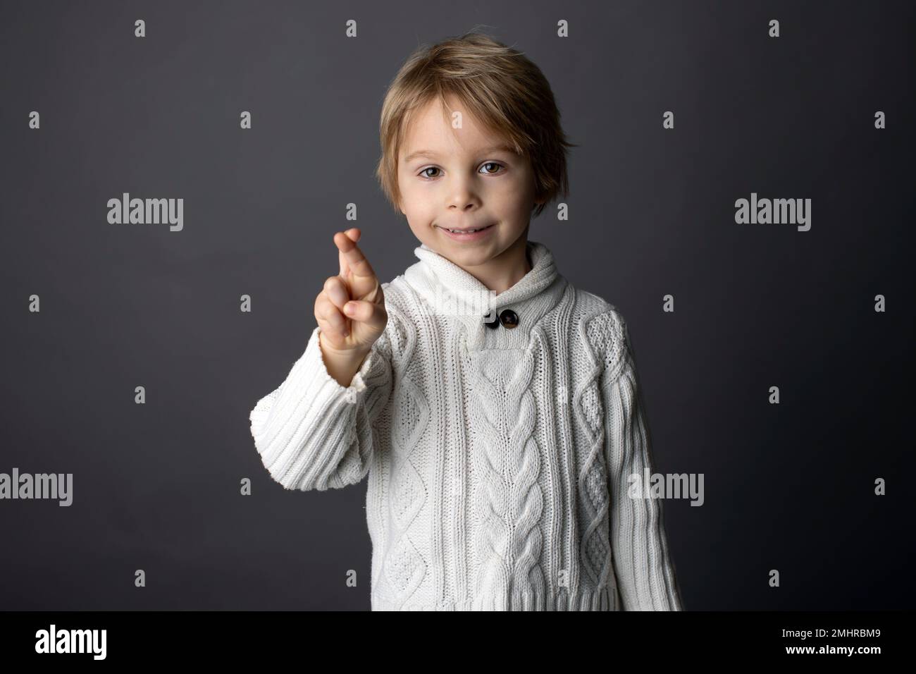 Cute little toddler boy, showing FINGER CROSSED gesture in sign ...