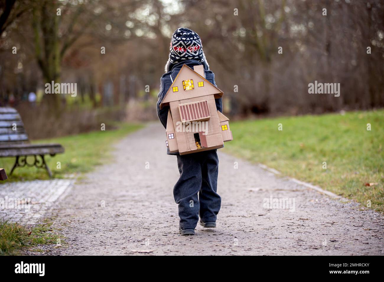 Little child, blond boy with pet dog, carying home on his back, kid ...