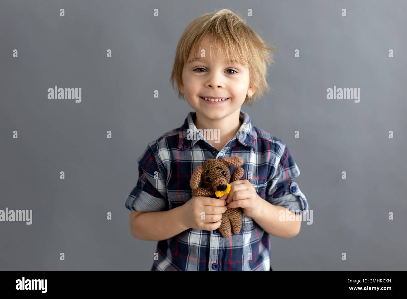 Little toddler child, blond boy, playing with handmade little stuffed ...