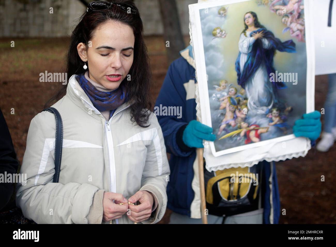 A woman prays the rosary outside the Fallen mausoleum near El Escorial ...