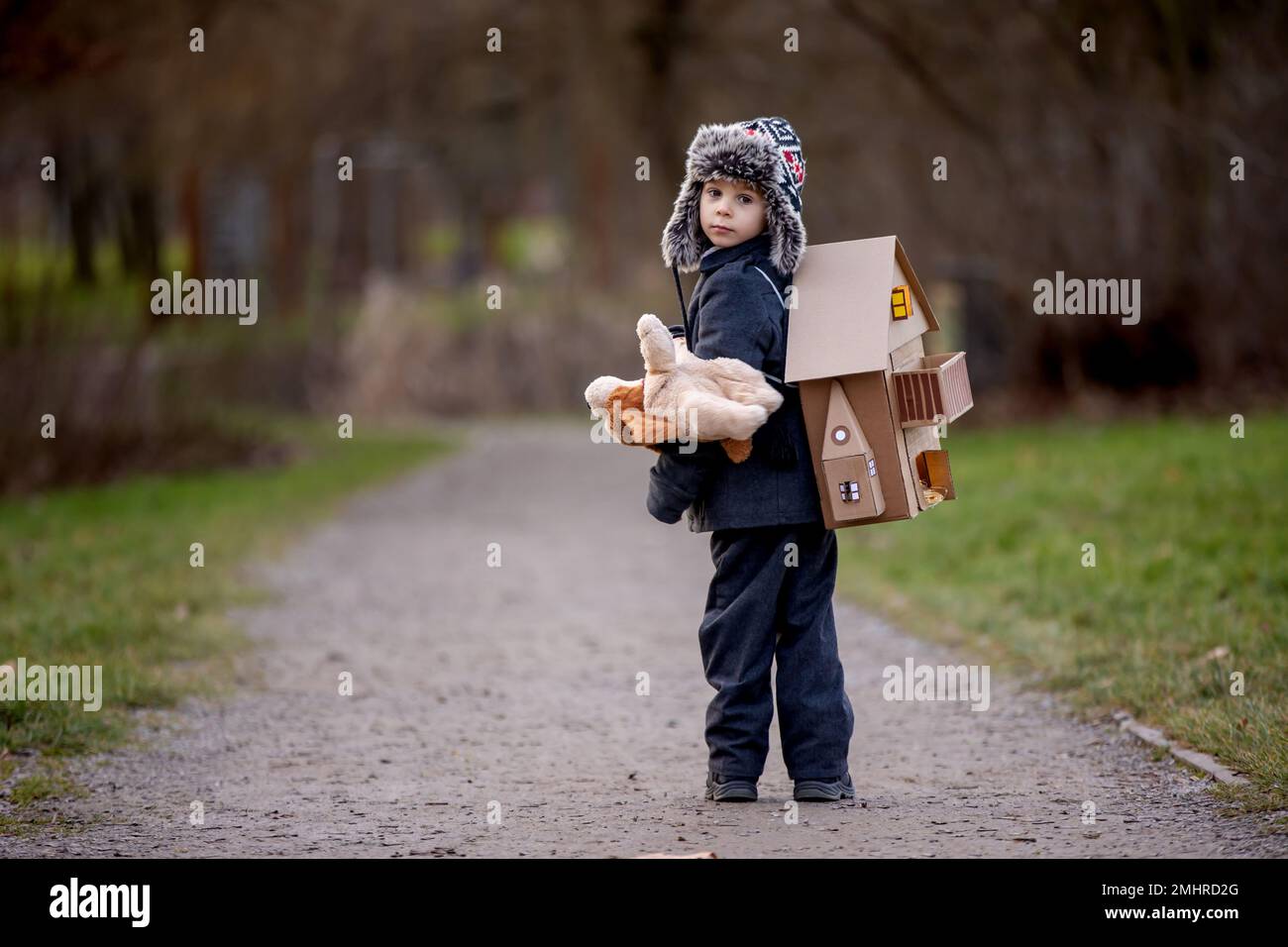 Little child, blond boy with pet dog, carying home on his back, kid ...