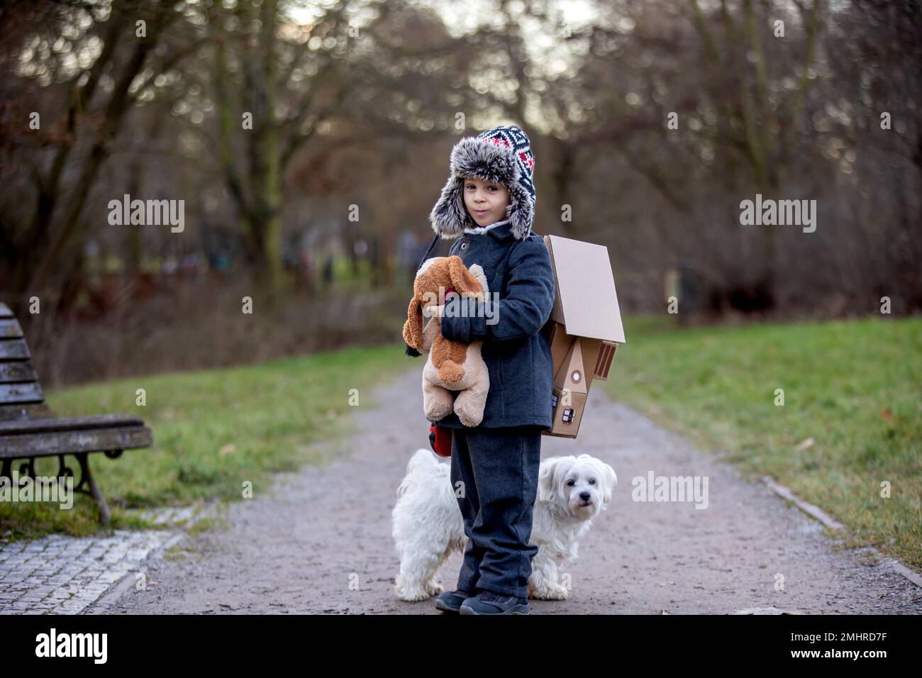 Little child, blond boy with pet dog, carying home on his back, kid ...
