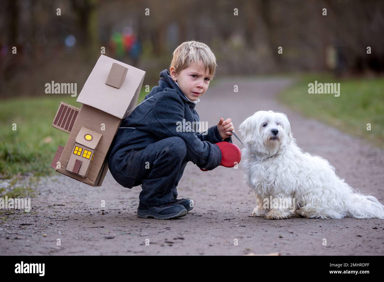 Little child, blond boy with pet dog, carying home on his back, kid ...