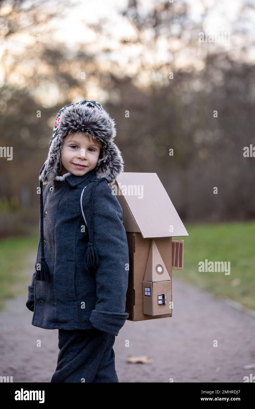 Little child, blond boy with pet dog, carying home on his back, kid ...
