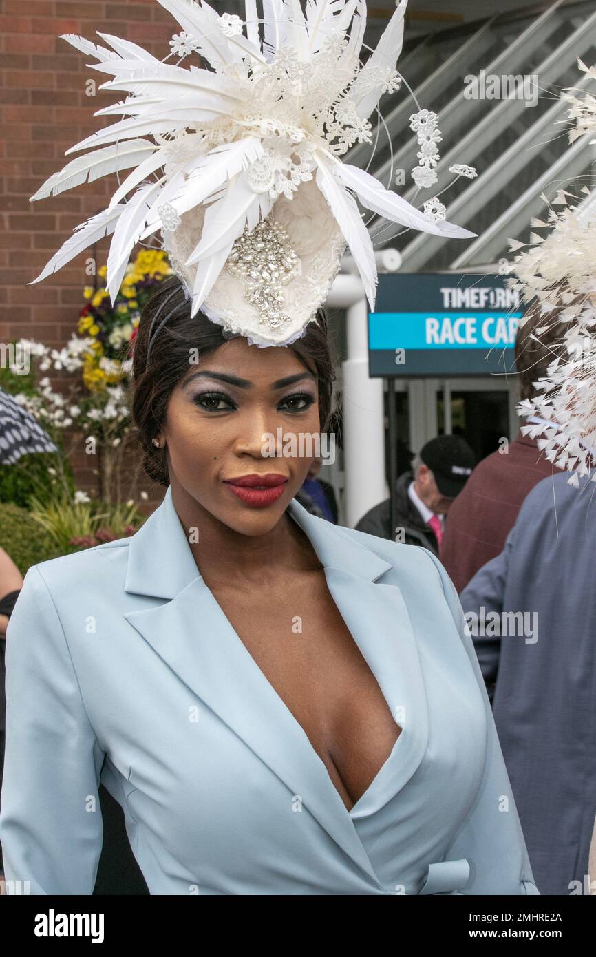 Women's high-end fashion, decorative fancy frocks and hats. Racegoers ...