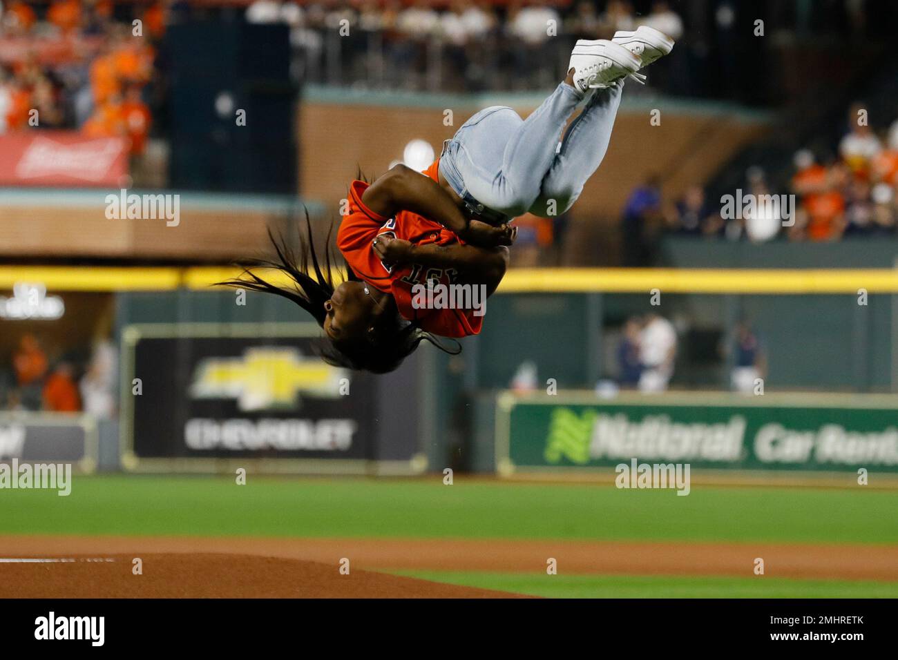 Gymnast Simone Biles does a flip before throwing the ceremonial first ...