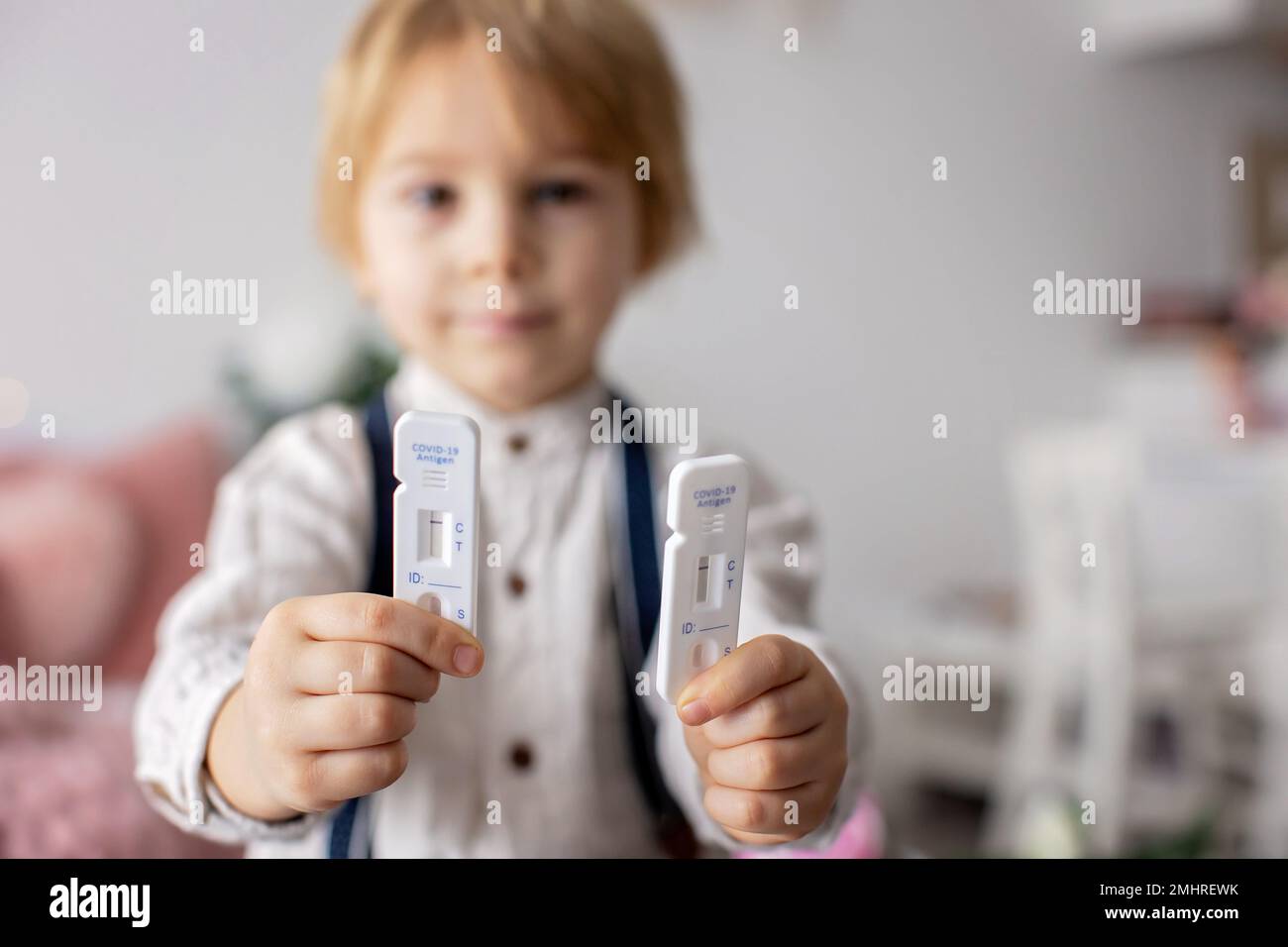 Child, holding two home made covid 19 SWAB antigen test, home allowed ...