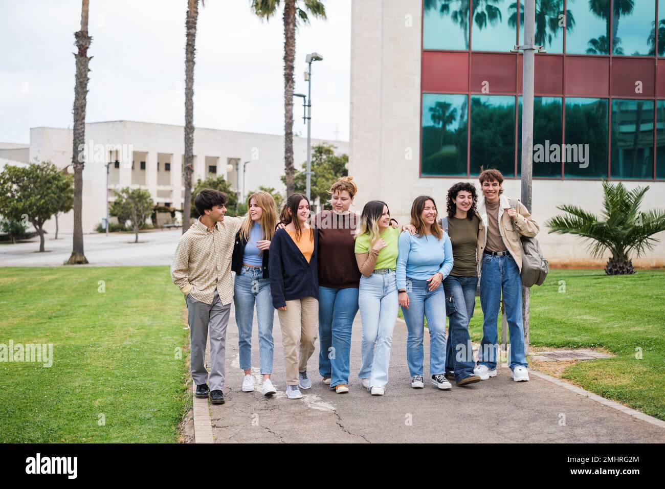 Group of university students walking around the campus after studying ...