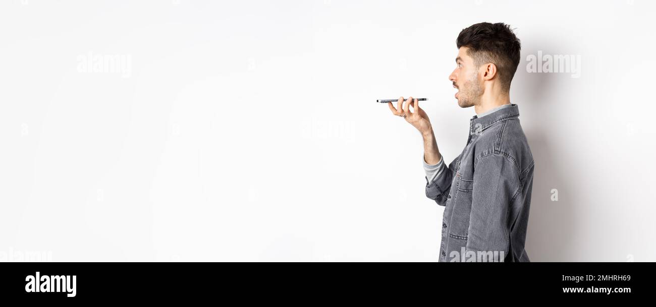 Profile of young man speaking at smartphone, translate with voice ...