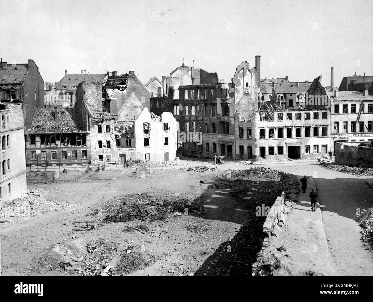 While civilians walk amid ruins of the city of Mainz, Germany, G.I.s ...