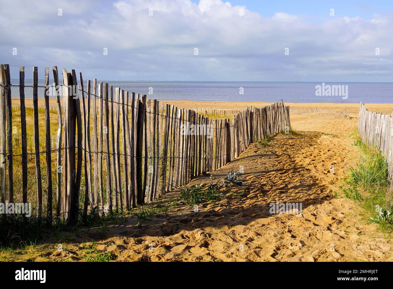 pedestrian path for access to the sand of the beach protected by wooden ...