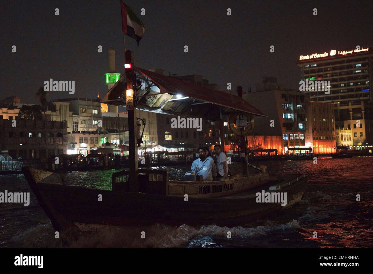 A traditional boat called an abra crosses the Dubai Creek in Dubai ...