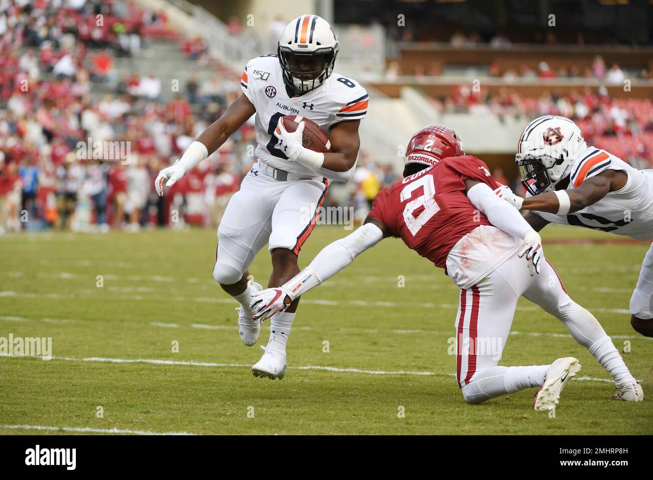 Auburn running back Shaun Shivers slips past Arkansas defenders to ...