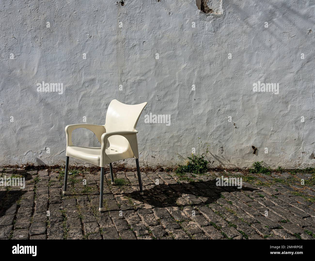 White Plastic Chair In Front Of Old House Facade, Teguise, Lanzarote ...