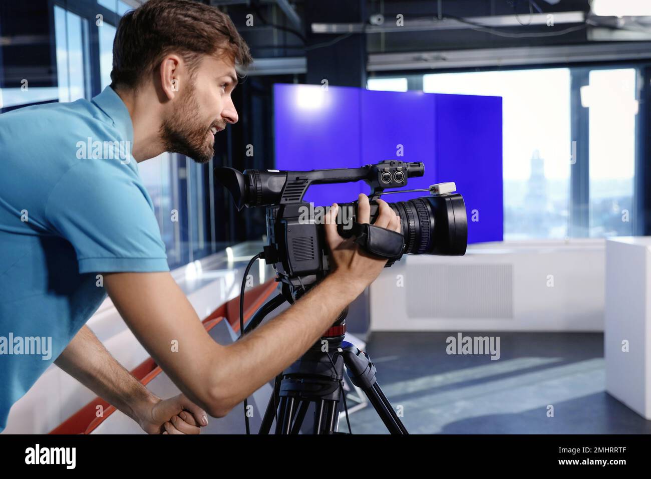 Professional video camera operator working in studio Stock Photo - Alamy