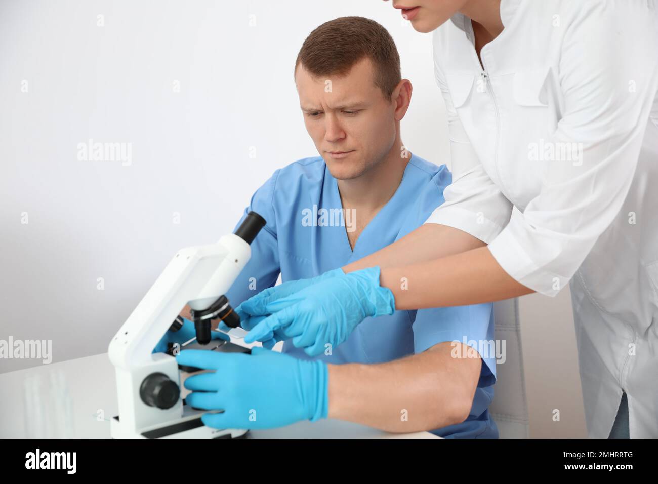 Medical students working with modern microscope in laboratory Stock ...