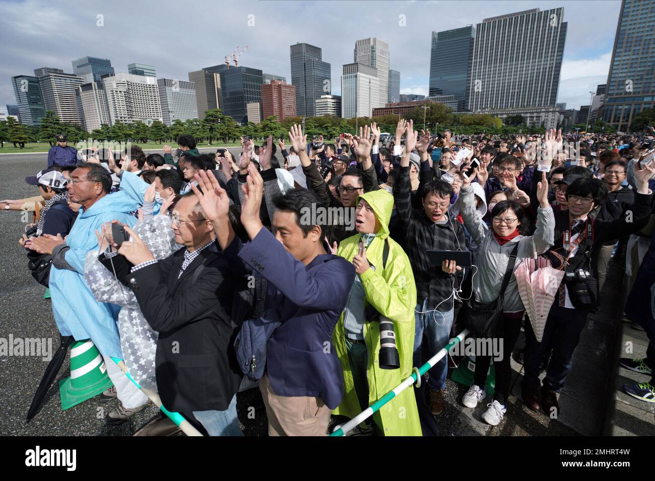 People outside of the Tokyo Imperial Palace follow Prime Minister ...