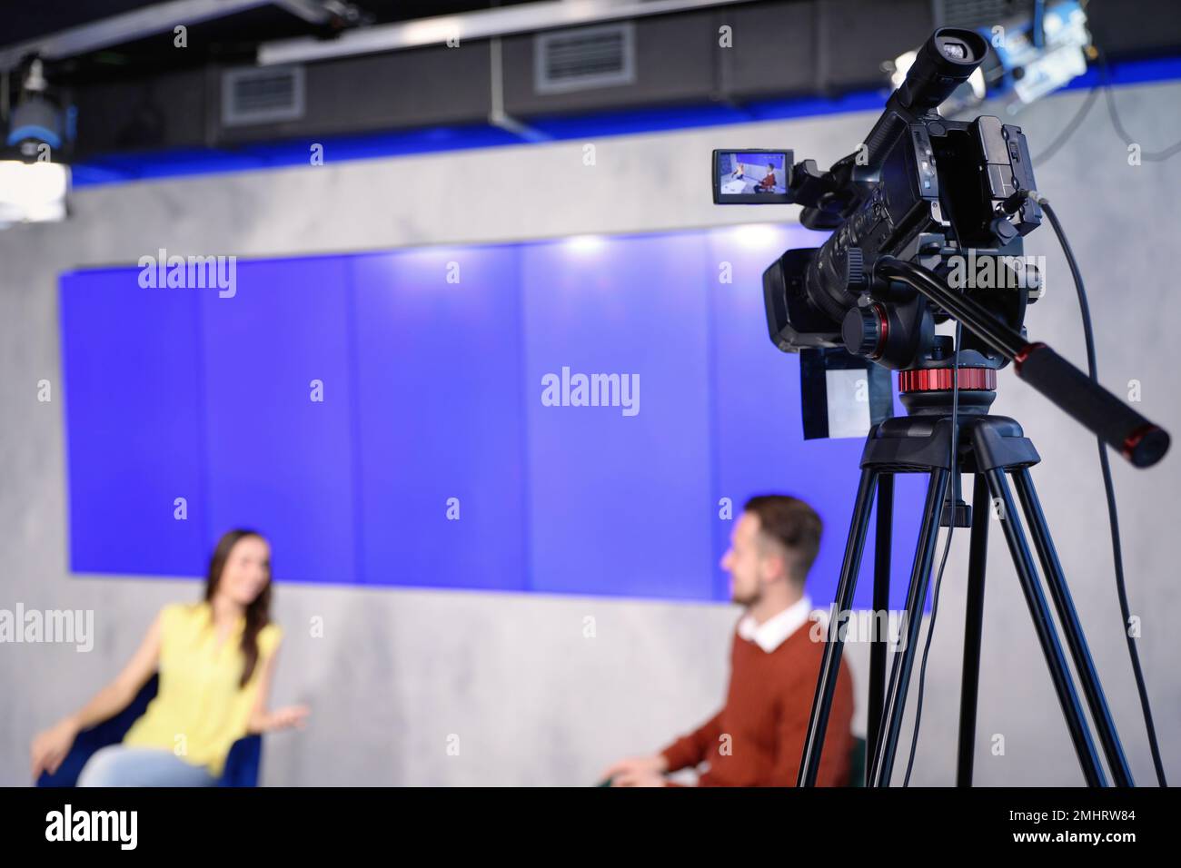 Presenters working in studio, focus on video camera Stock Photo - Alamy