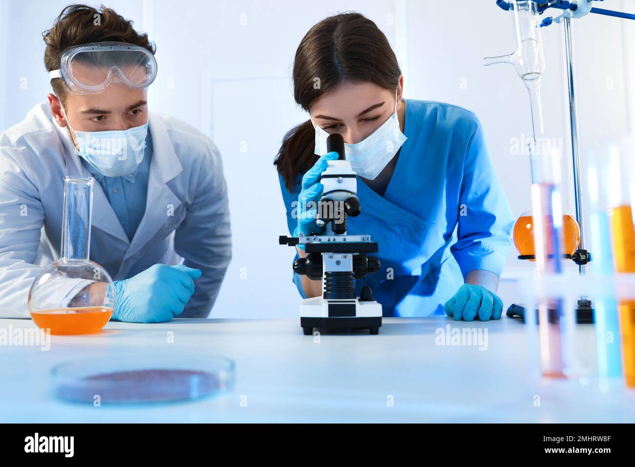 Scientists doing research and analysis with microscope in laboratory ...