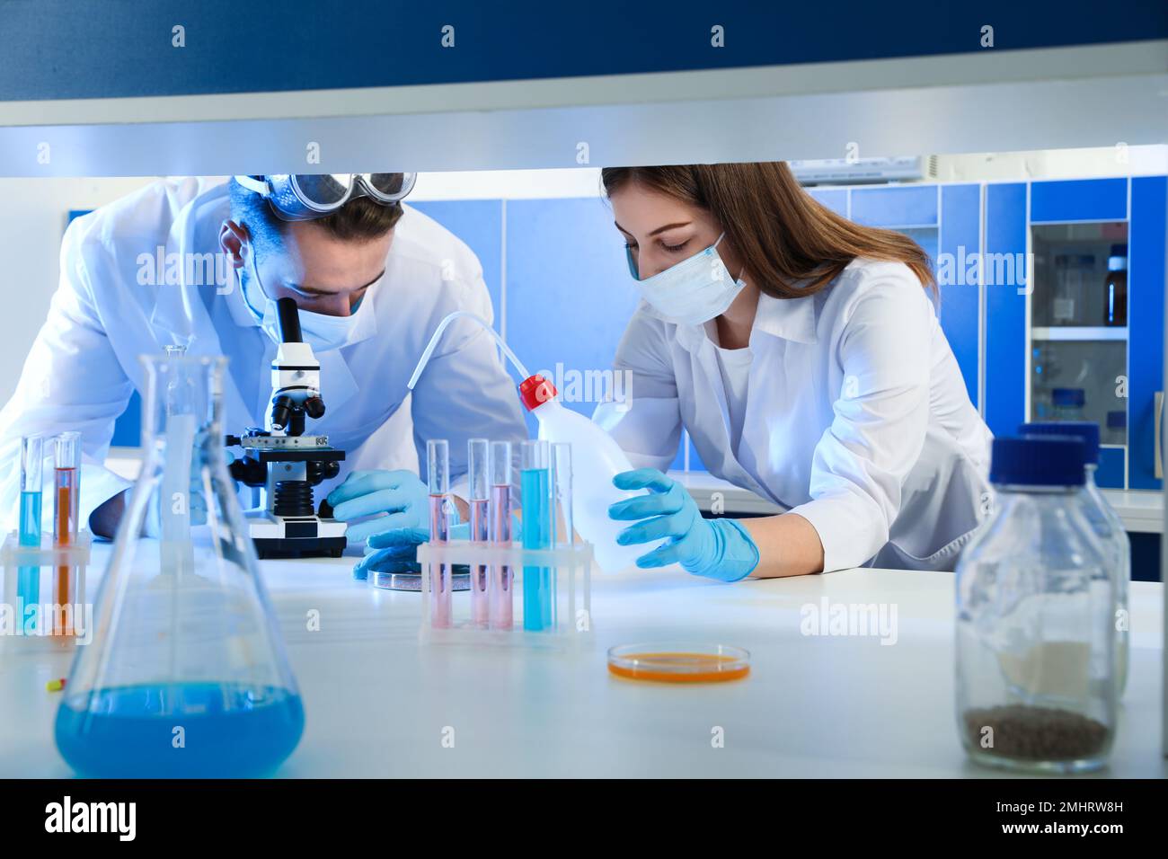 Scientists doing research and analysis with microscope in laboratory ...