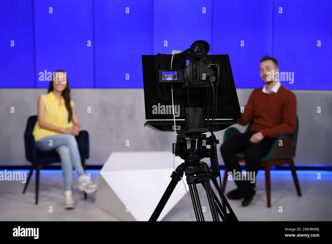 Presenters working in studio, focus on video camera Stock Photo - Alamy