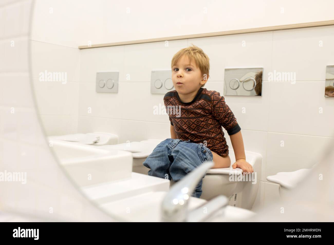 Cute child, blond boy., going to toilet in kindergarden Stock Photo - Alamy