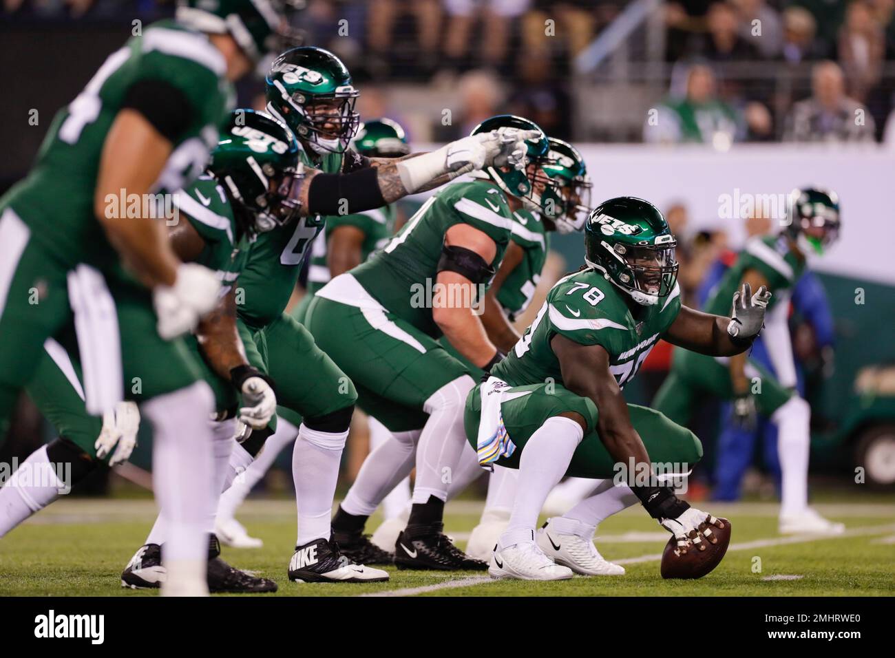 New York Jets center Jonotthan Harrison (78) calls out defenders during ...