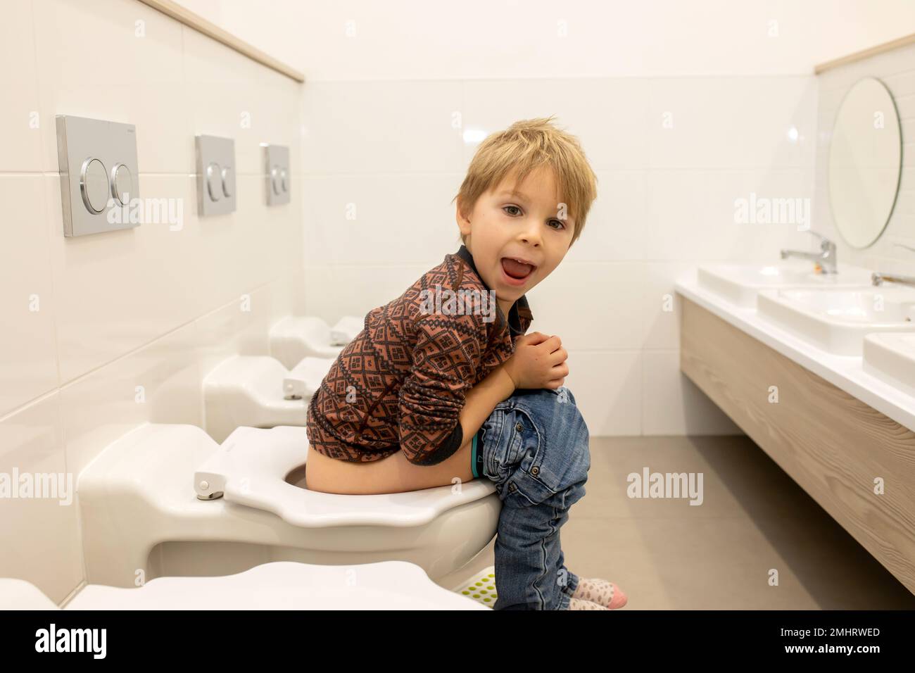 Cute child, blond boy., going to toilet in kindergarden Stock Photo - Alamy