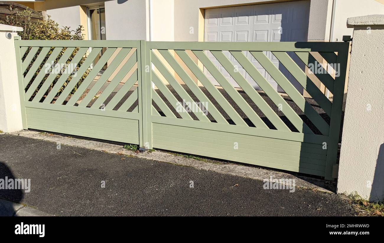portal modern green gate and steel entrance door of property house ...