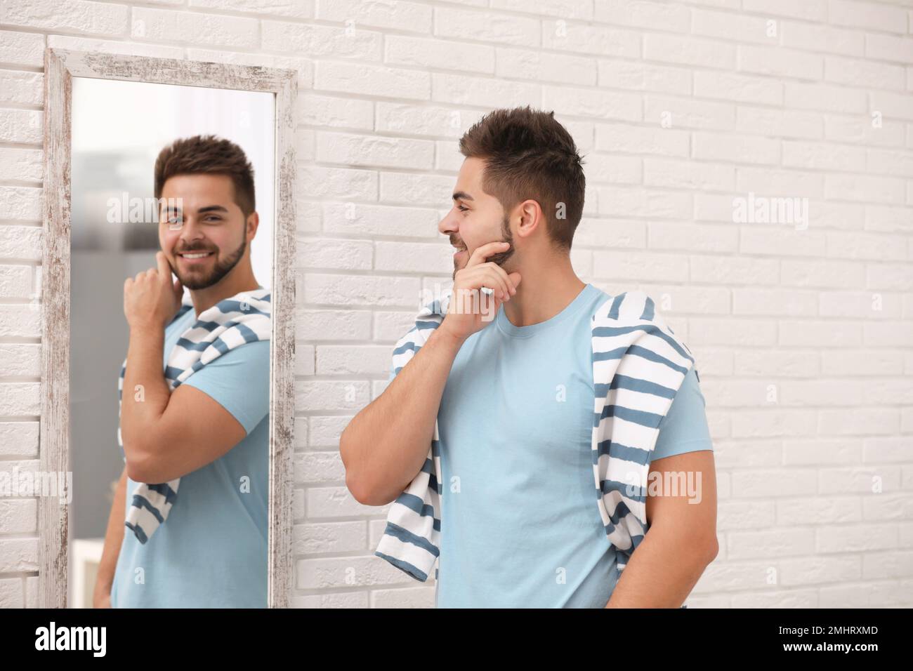 Man looking at himself in the mirror hi-res stock photography and ...
