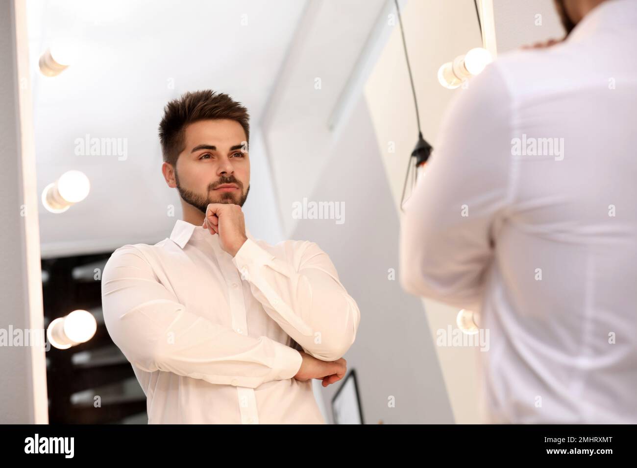 Man looking at himself in the mirror hi-res stock photography and ...