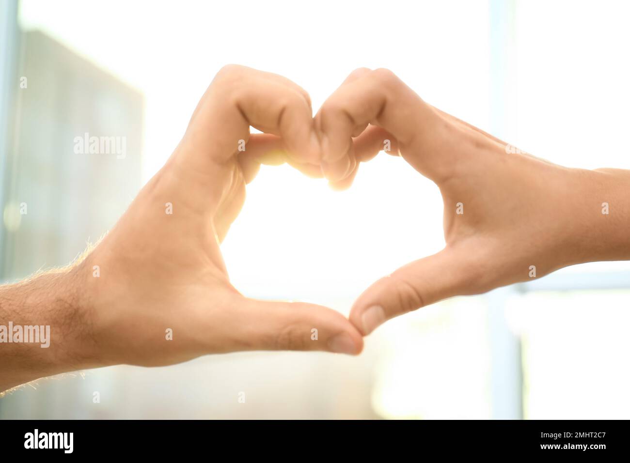 Young people forming heart with hands indoors, closeup. Happy family ...