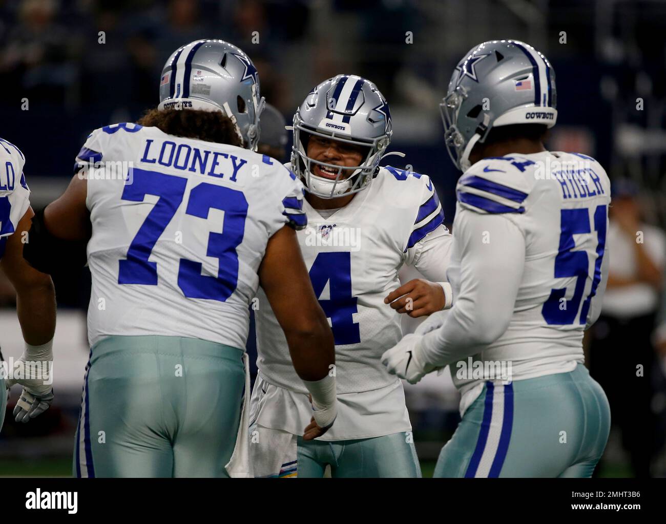 Dallas Cowboys' Dak Prescott (4) center, motivates Joe Looney (73) and ...