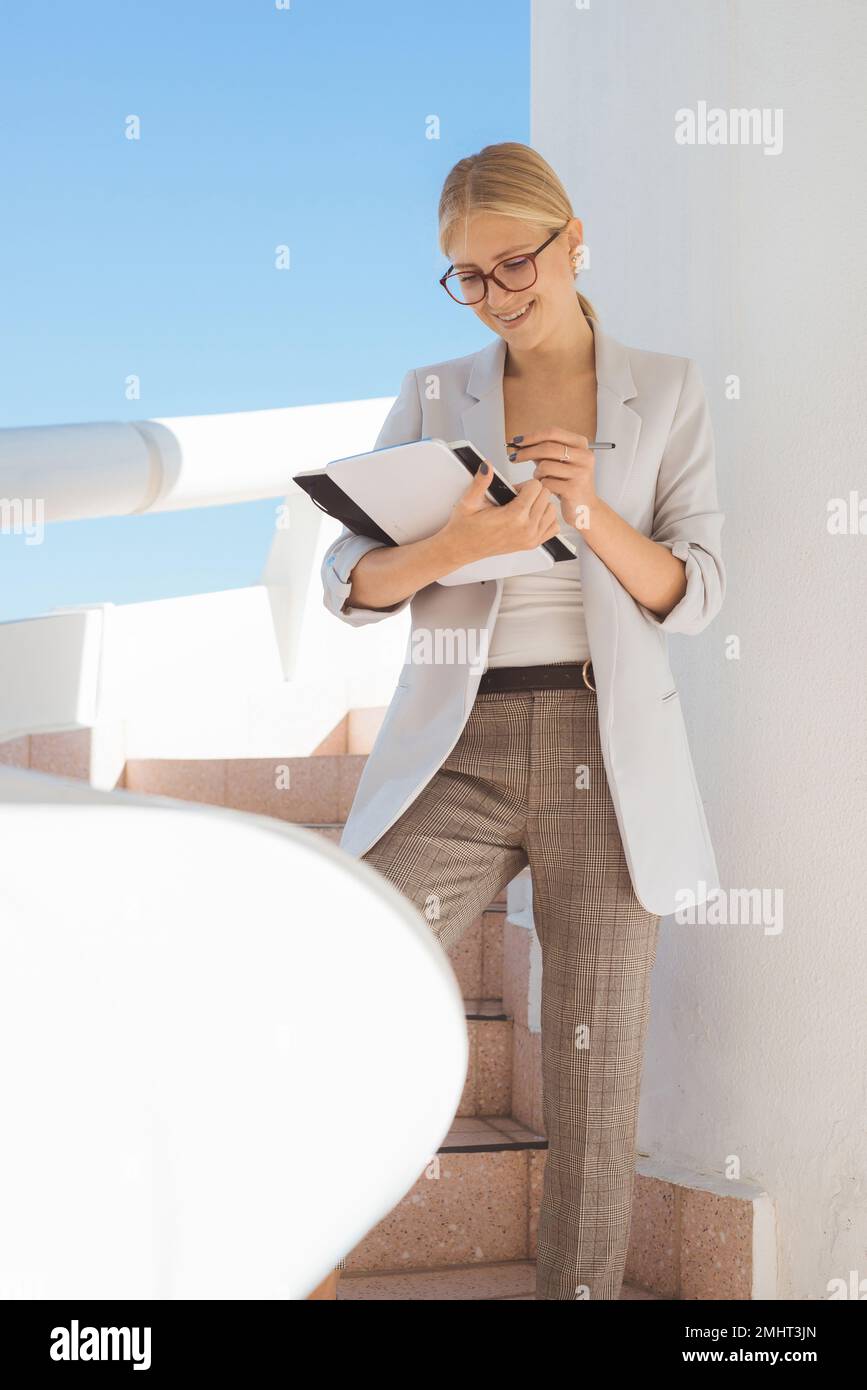 Young female executive standing hi-res stock photography and images - Alamy