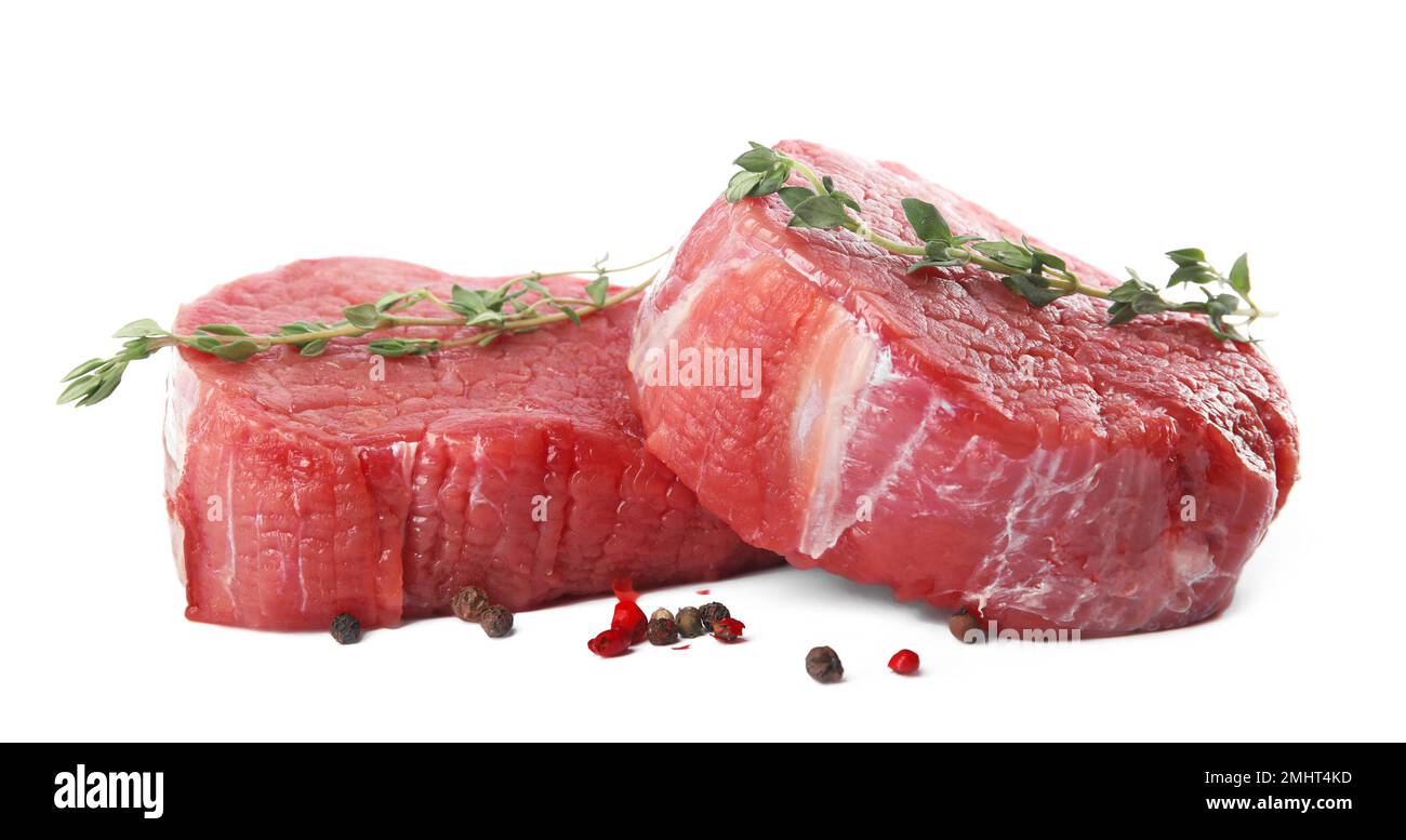 Fresh raw beef cut with thyme and peppers mix isolated on white Stock ...