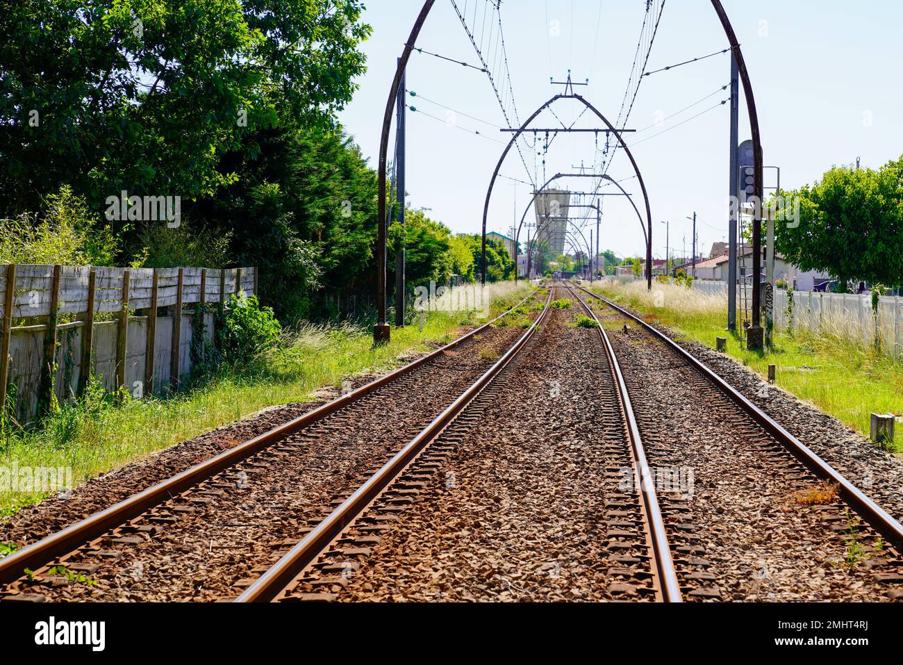 train rails in country and electric poles arch Stock Photo - Alamy