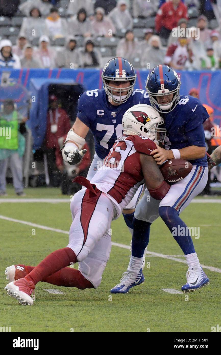 Arizona Cardinals' Terrell Suggs, bottom, knocks the ball out of New ...