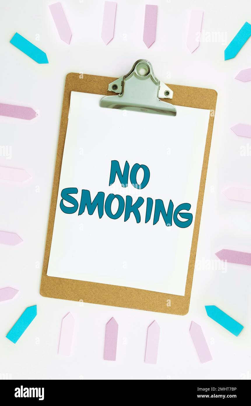Hand writing sign No Smoking. Word Written on using tobacco is forbiden ...