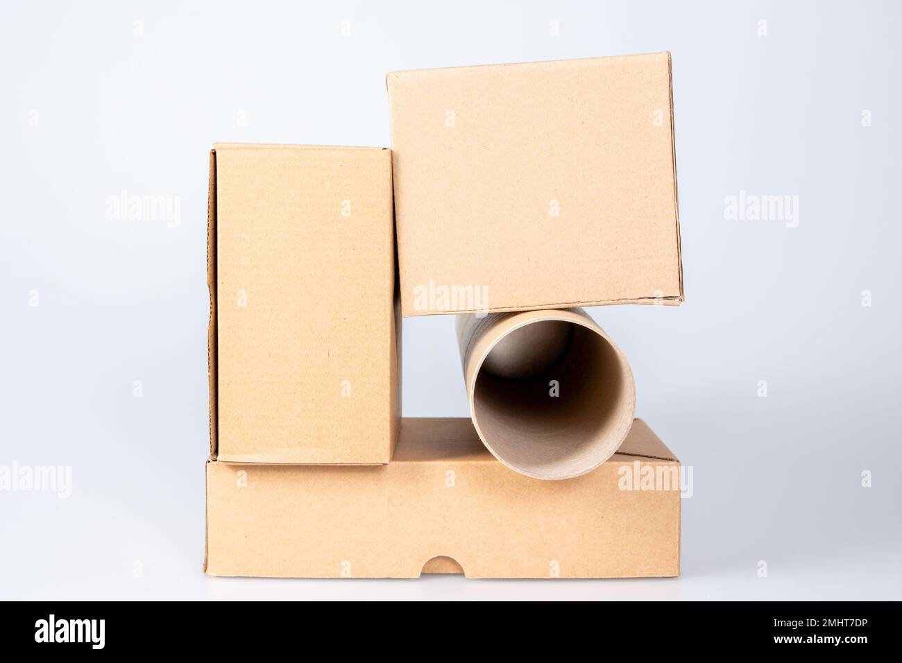 Stack of cardboard boxes with card board tube on white background Stock ...