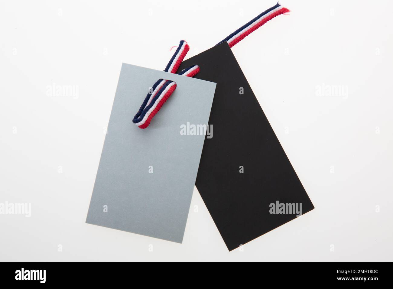 two grey and black tag label with tricolor ribbon blue white red ...