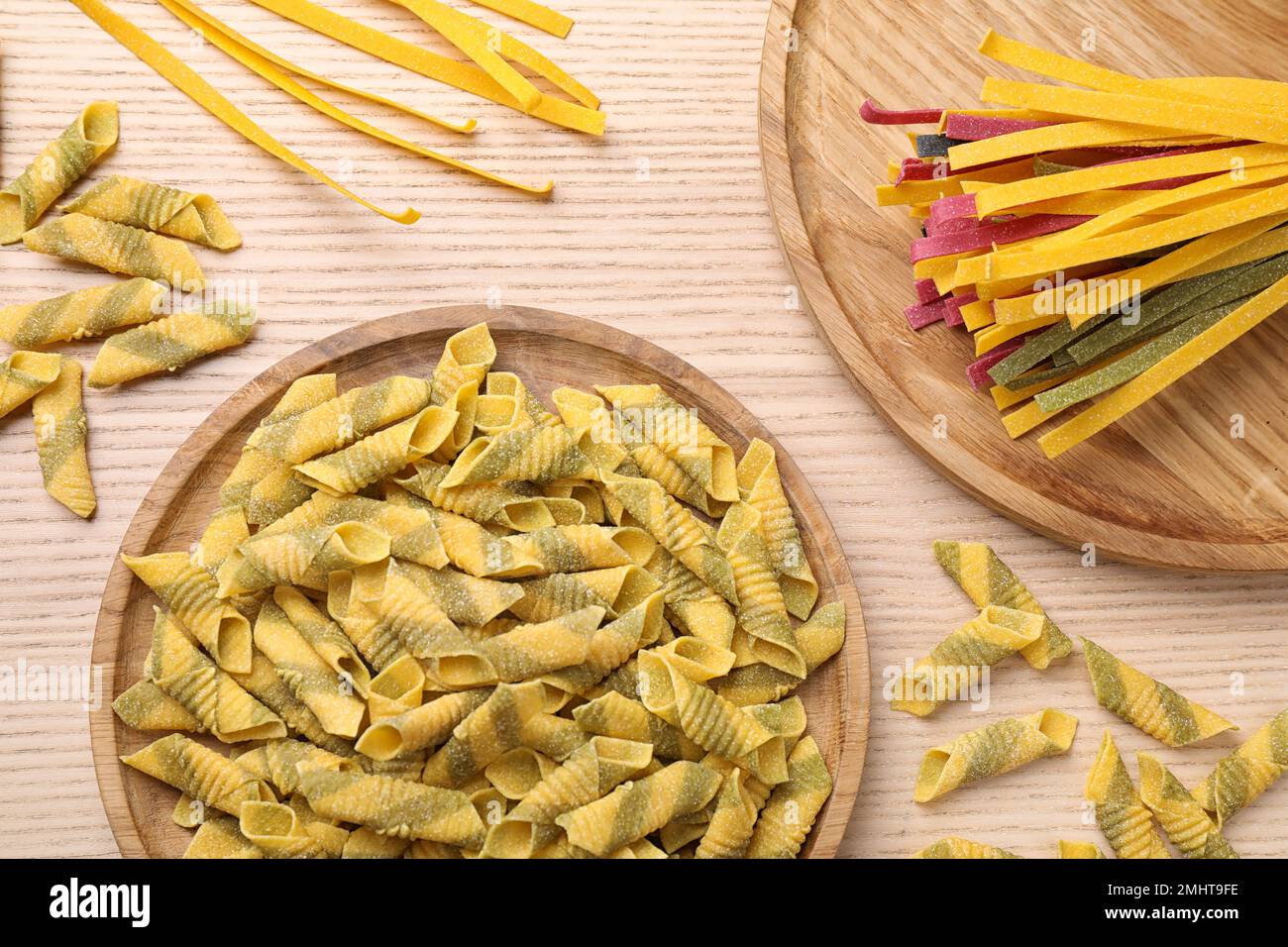 Flat lay composition with different types of pasta on wooden background ...
