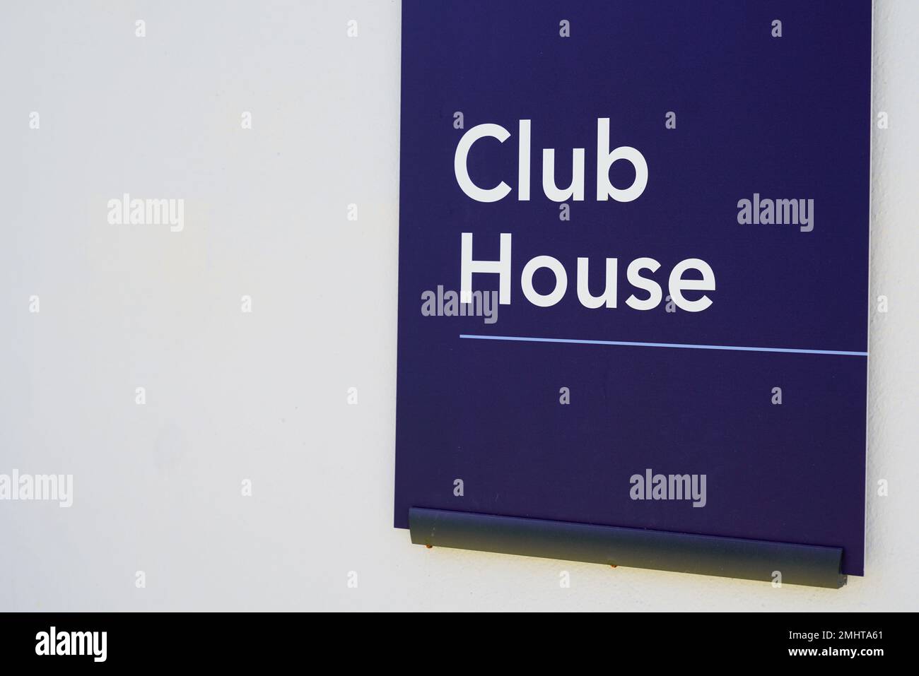 Club house text panel sign on white wall background Stock Photo - Alamy