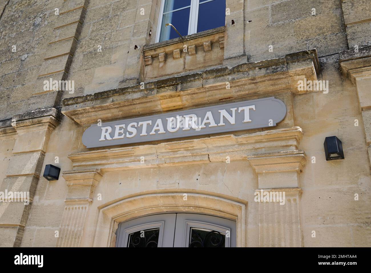 restaurant text sign on old french building city street storefront ...