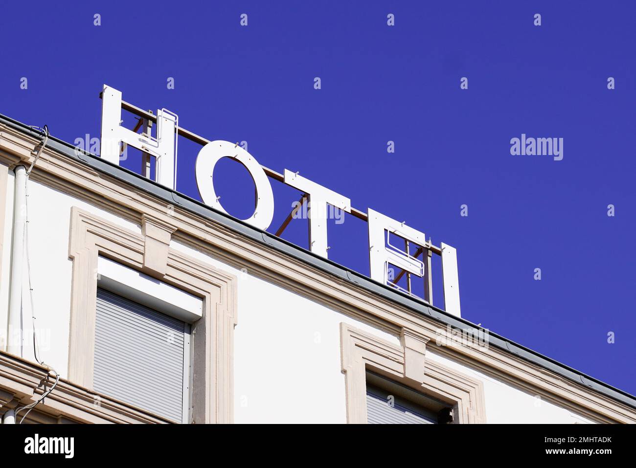 Hotel sign text on roof Building in tourist city Stock Photo - Alamy