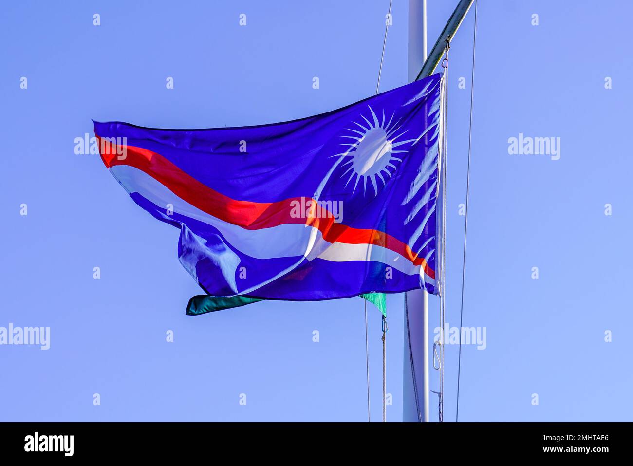 Marshall Islands flag is a blue field with two stripes radiating from ...