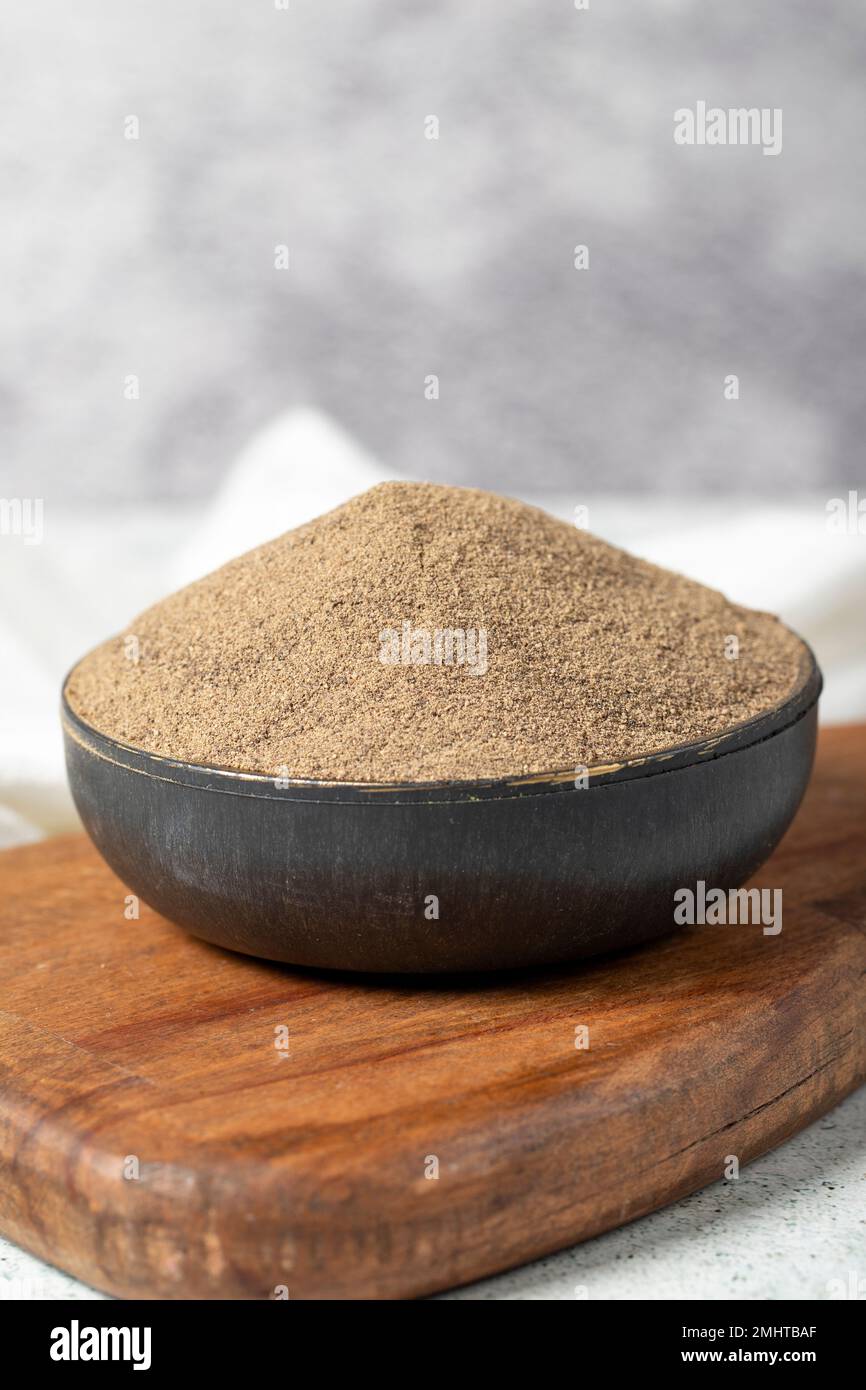 Black pepper spice. Ground black pepper spice on stone background. Dry ...