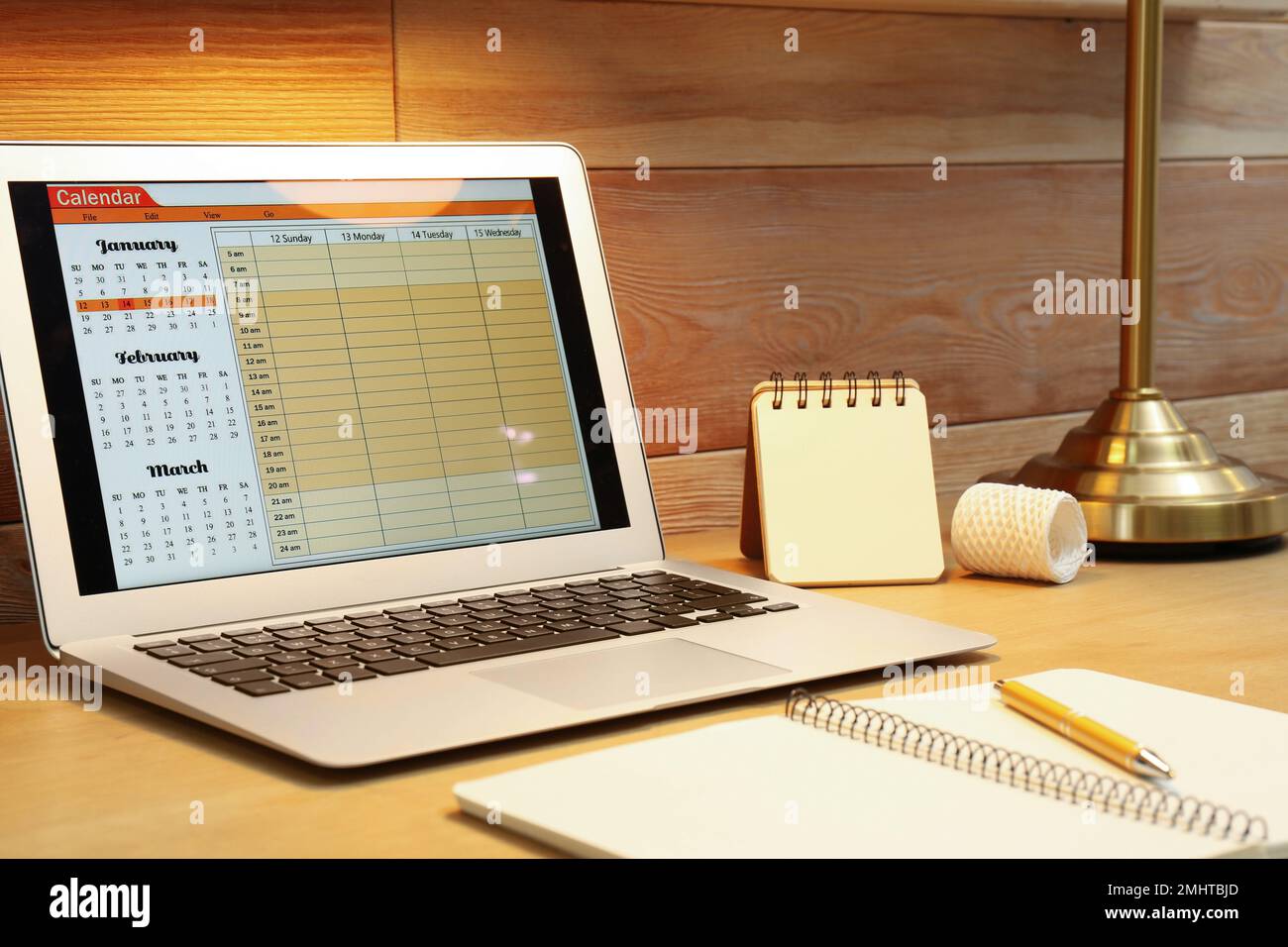 Modern laptop with calendar on screen in office Stock Photo - Alamy