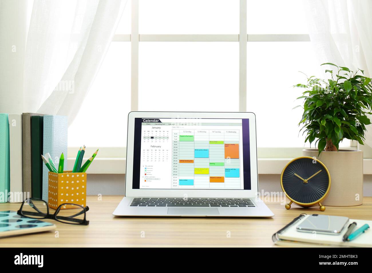 Modern laptop with calendar on screen in office Stock Photo - Alamy